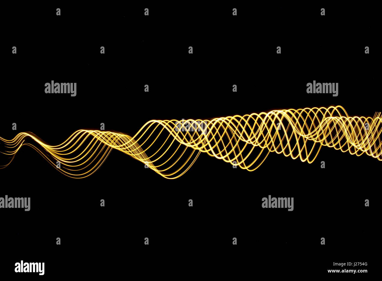 Long exposure photograph of neon gold colour in an abstract wavy ...