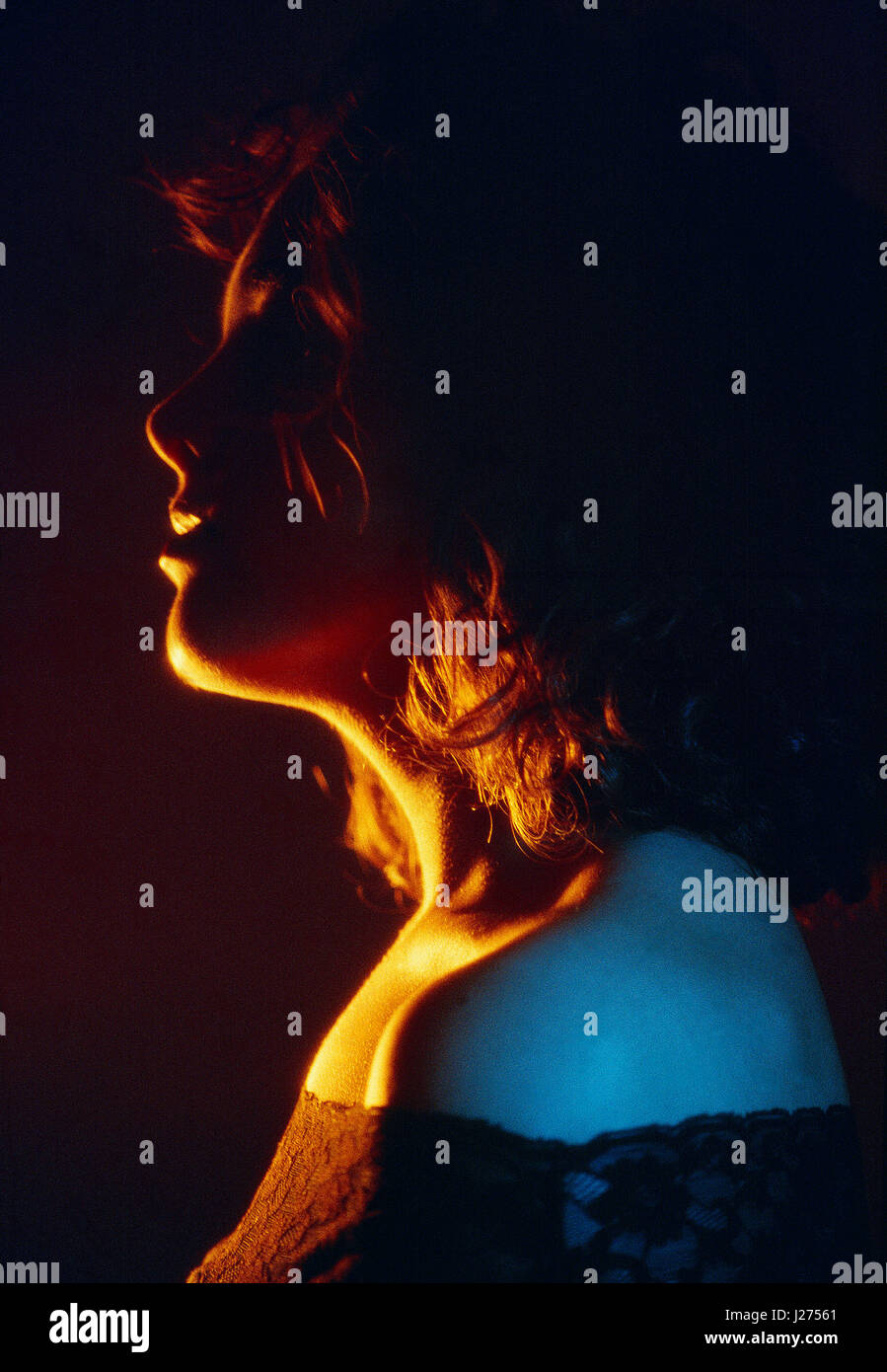 Profile portrait of young woman. Low key Stock Photo - Alamy
