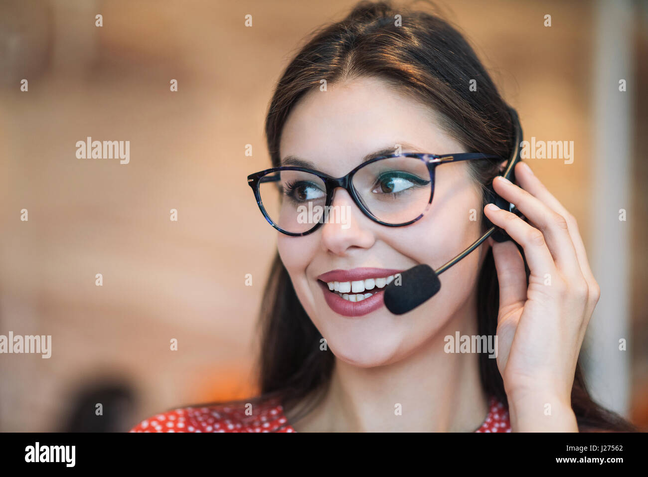 Young female technical support dispatcher working in office, closeup ...