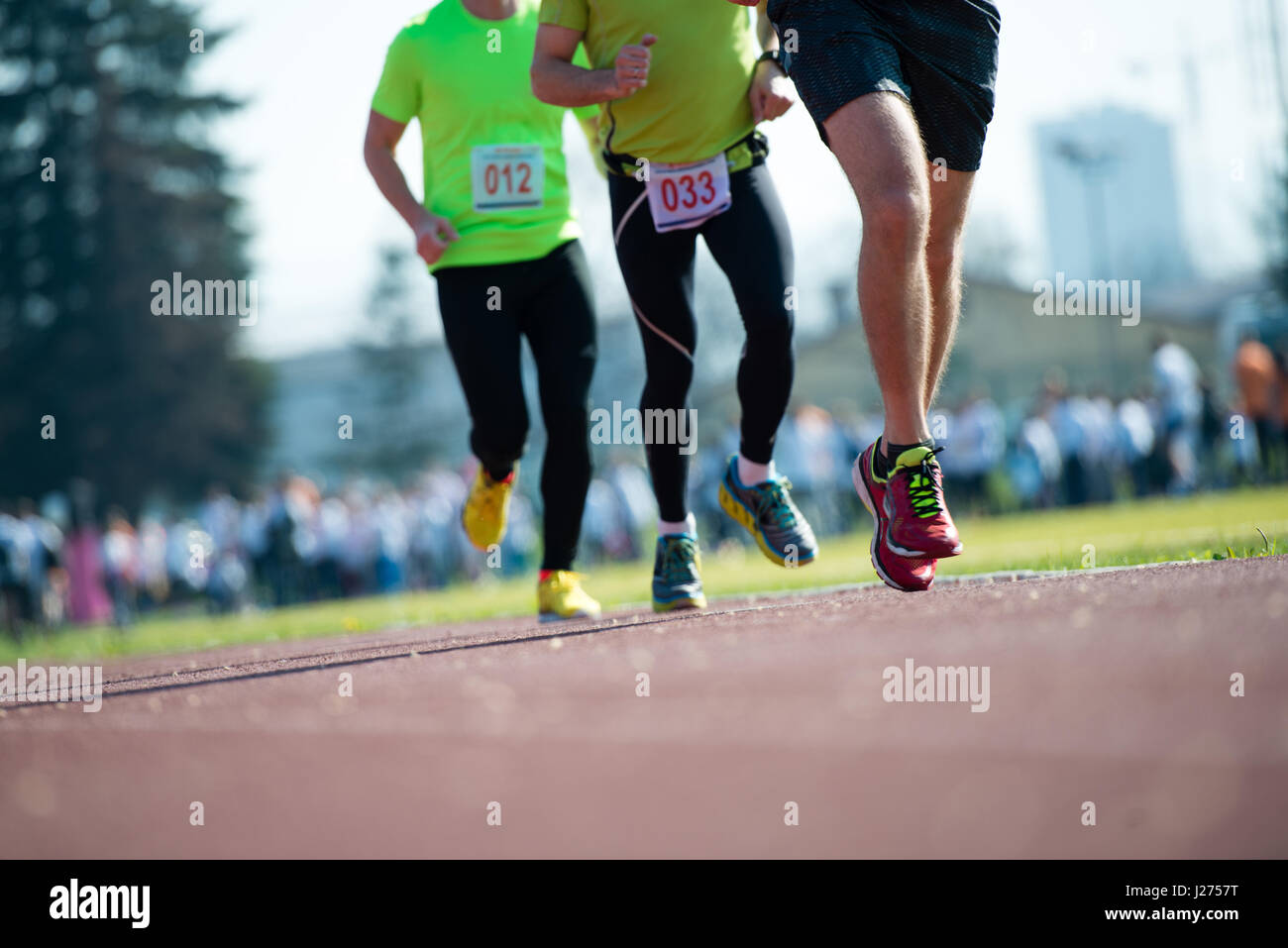 Group of marathon racers runningon the track Stock Photo - Alamy