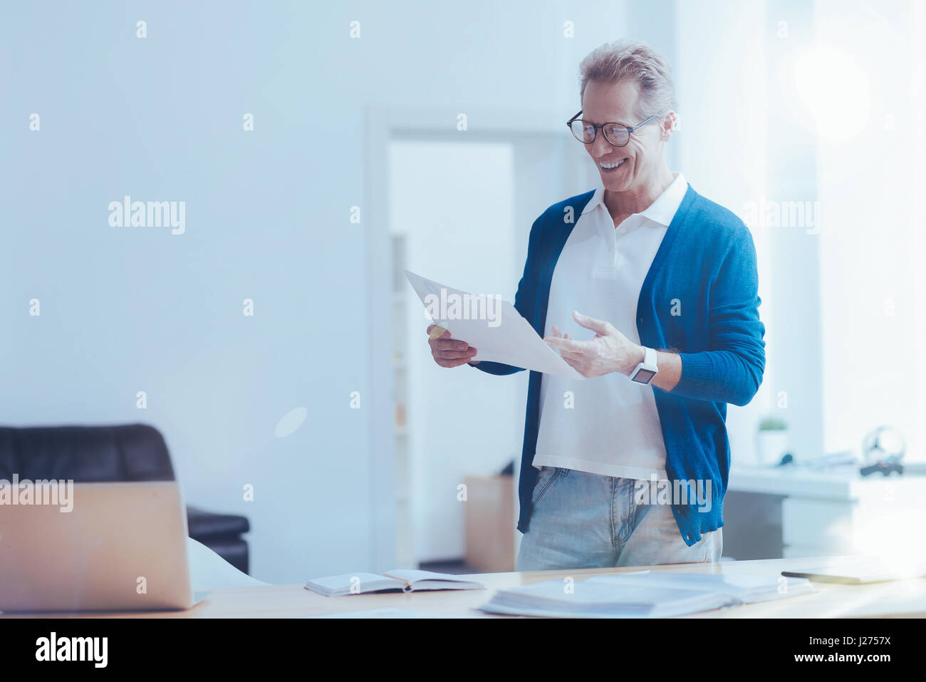Cheerful office worker working the project Stock Photo - Alamy
