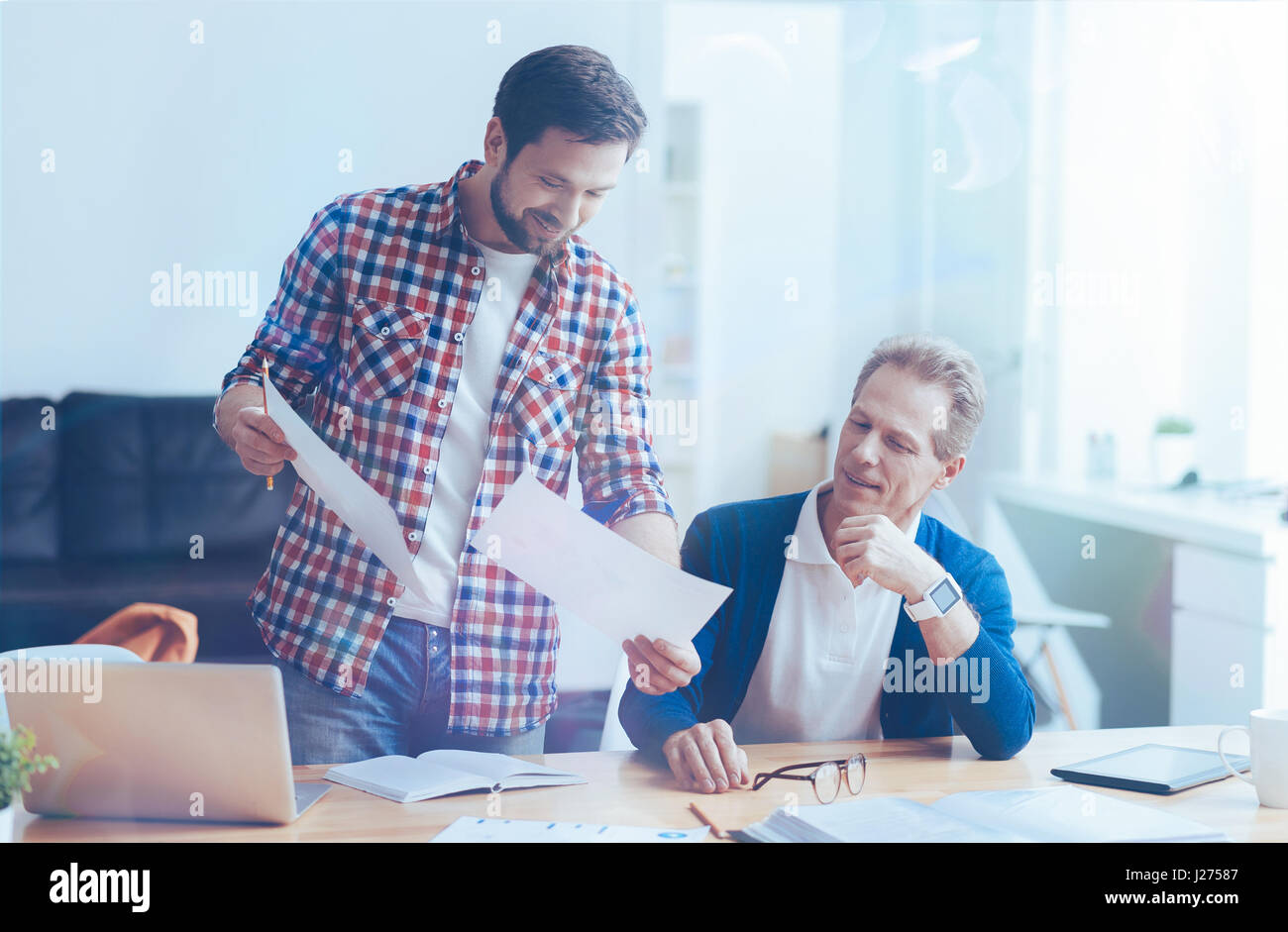 Smiling male colleagues working together in the office Stock Photo - Alamy