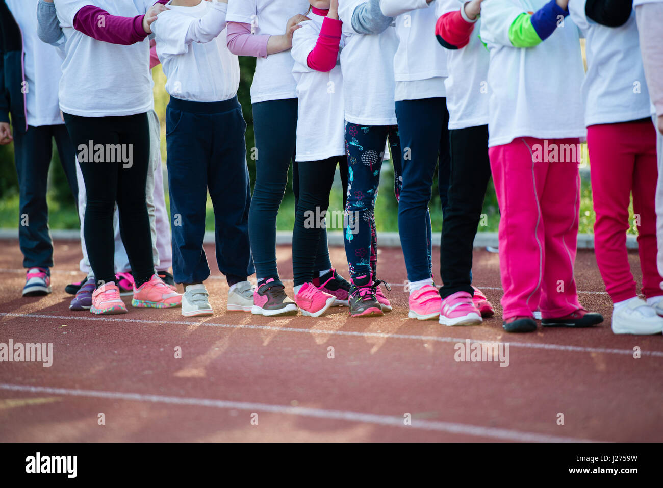 Children in ready position to run on track, closeup Stock Photo - Alamy