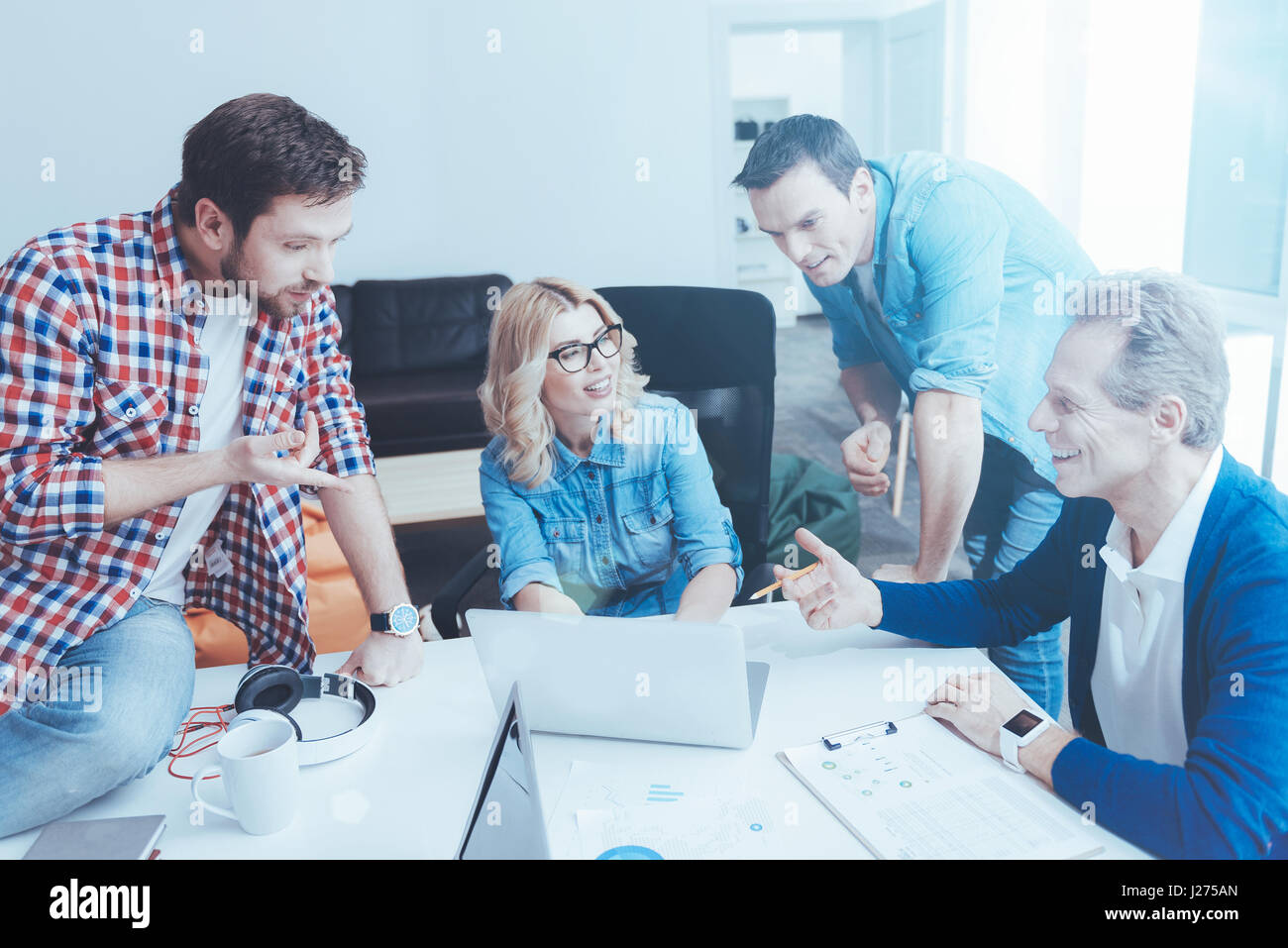 INvolved positive colleagues discussing project together Stock Photo ...