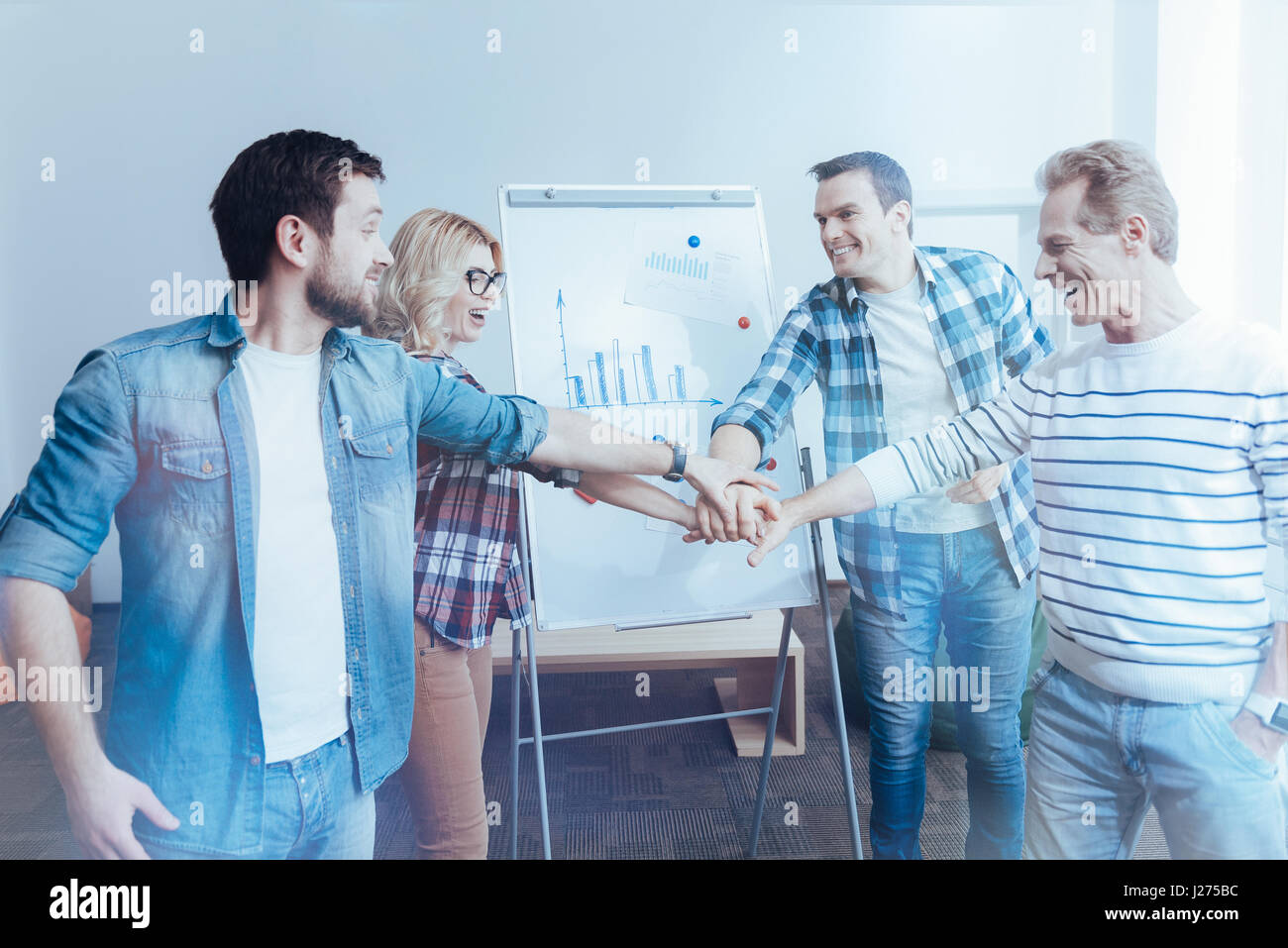 Cheerful colleagues celebrating success Stock Photo - Alamy