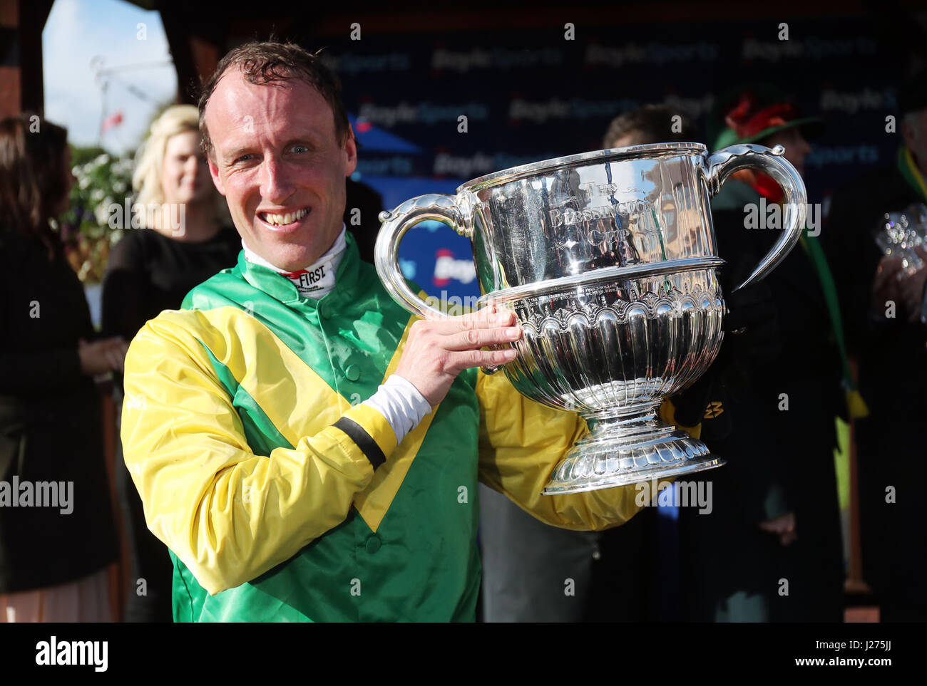 Jockey Robbie Power celebrates with the trophy after riding Fox Norton ...