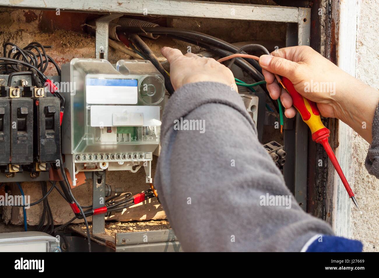 Repair of old electrical switchgear. An electrician replaces old ...