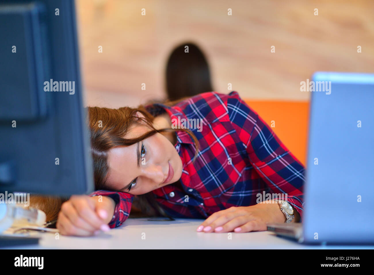 Portrait of tired young business woman with laptop computer Stock Photo ...