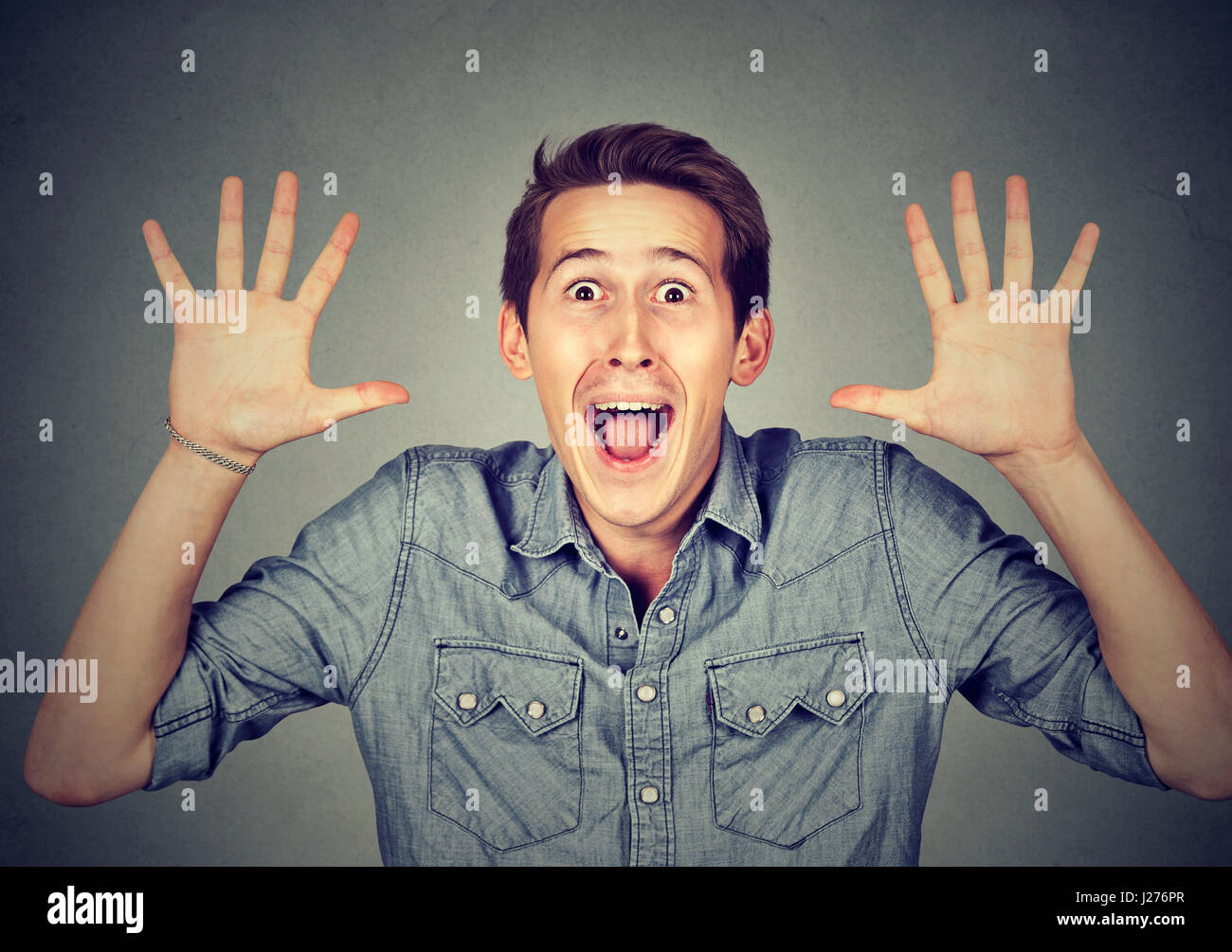 Happy young man going crazy screaming super excited surprised isolated ...