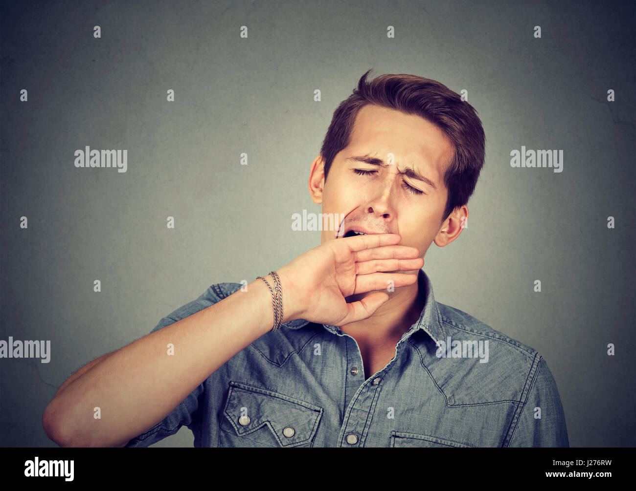 Sleepy young man yawning. Sleep deprivation, burnout, laziness concept ...