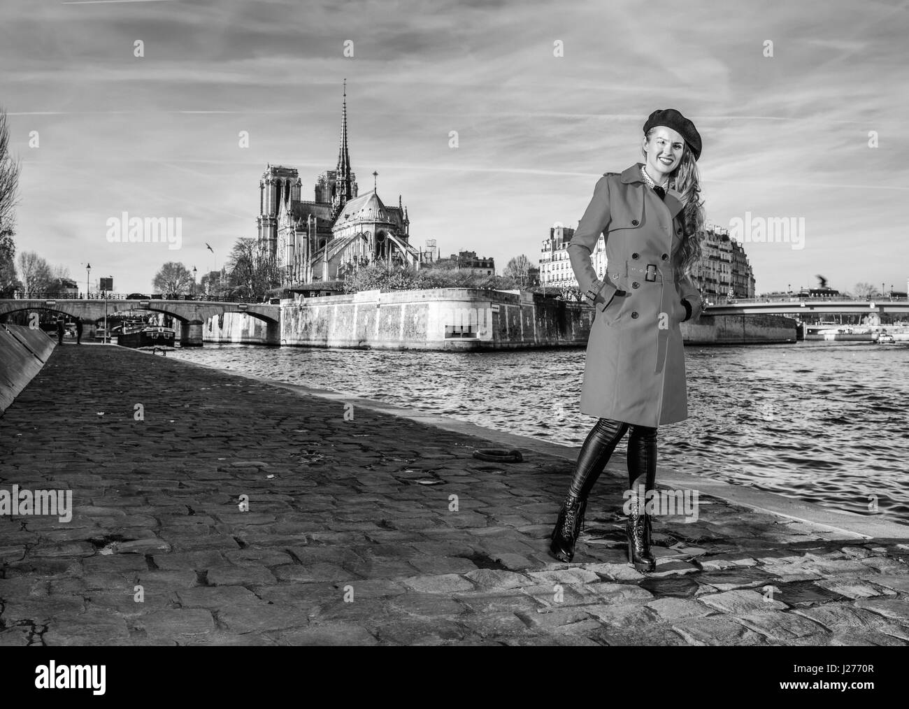 Bright in Paris. smiling elegant traveller woman in red trench coat ...