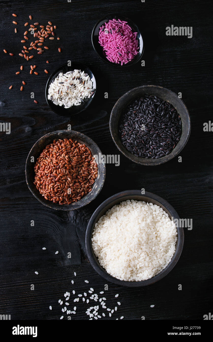 Variety assortment of raw uncooked colorful rice white, black, brown ...