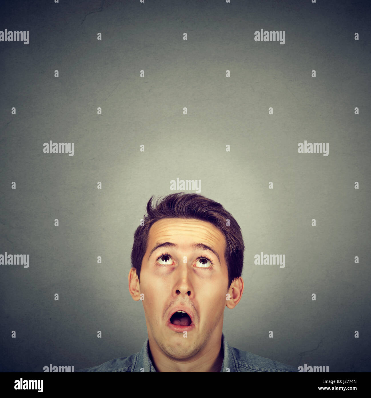 Surprised young man looking up Stock Photo - Alamy Surprised young man looking up Stock Photo - Alamy