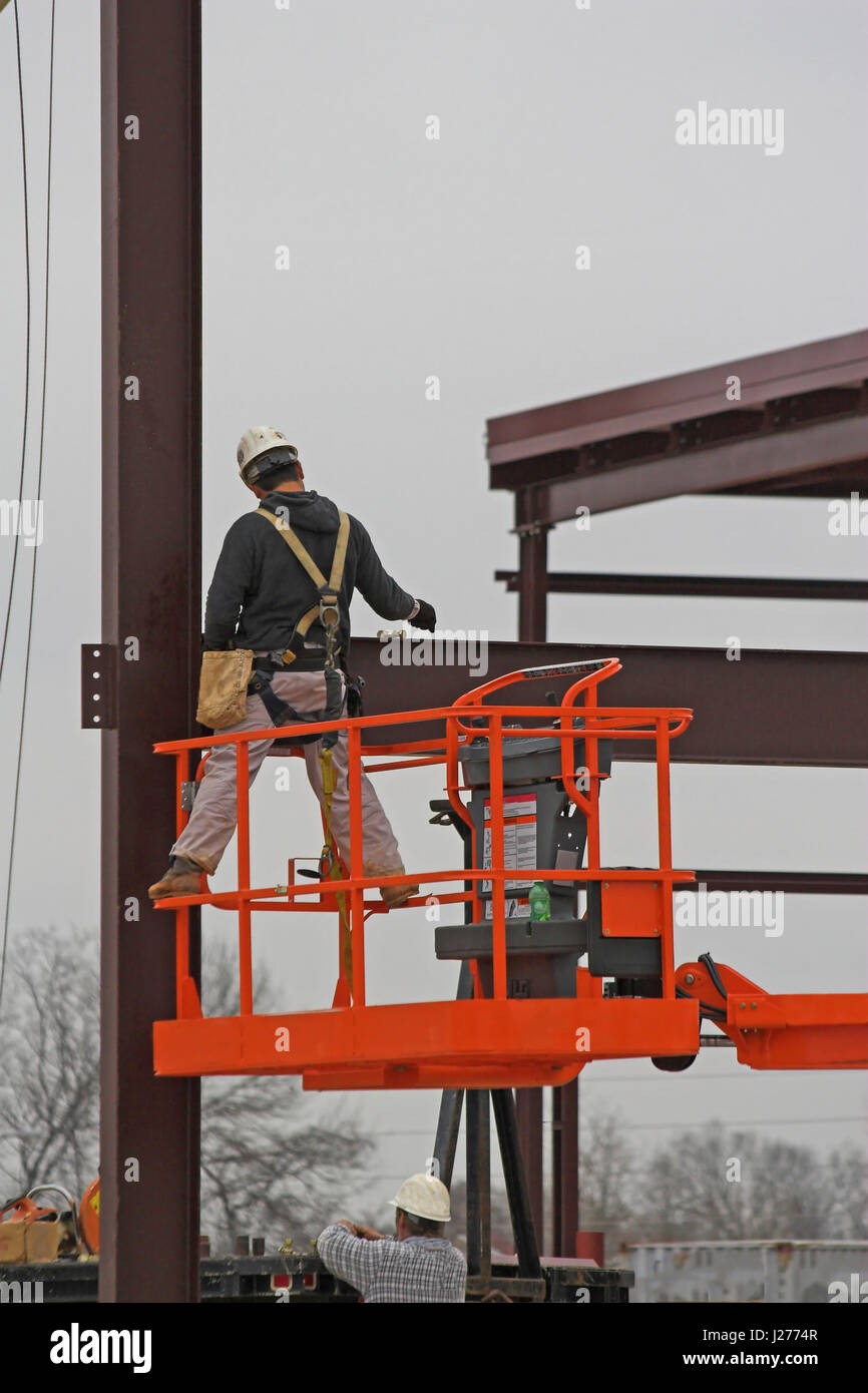 Steel worker bolting together steel beams for new building Stock Photo ...