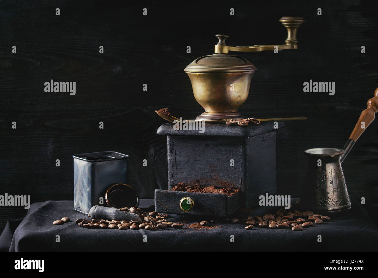 Old vintage grinder with roasted coffee beans and grind coffee in tin ...