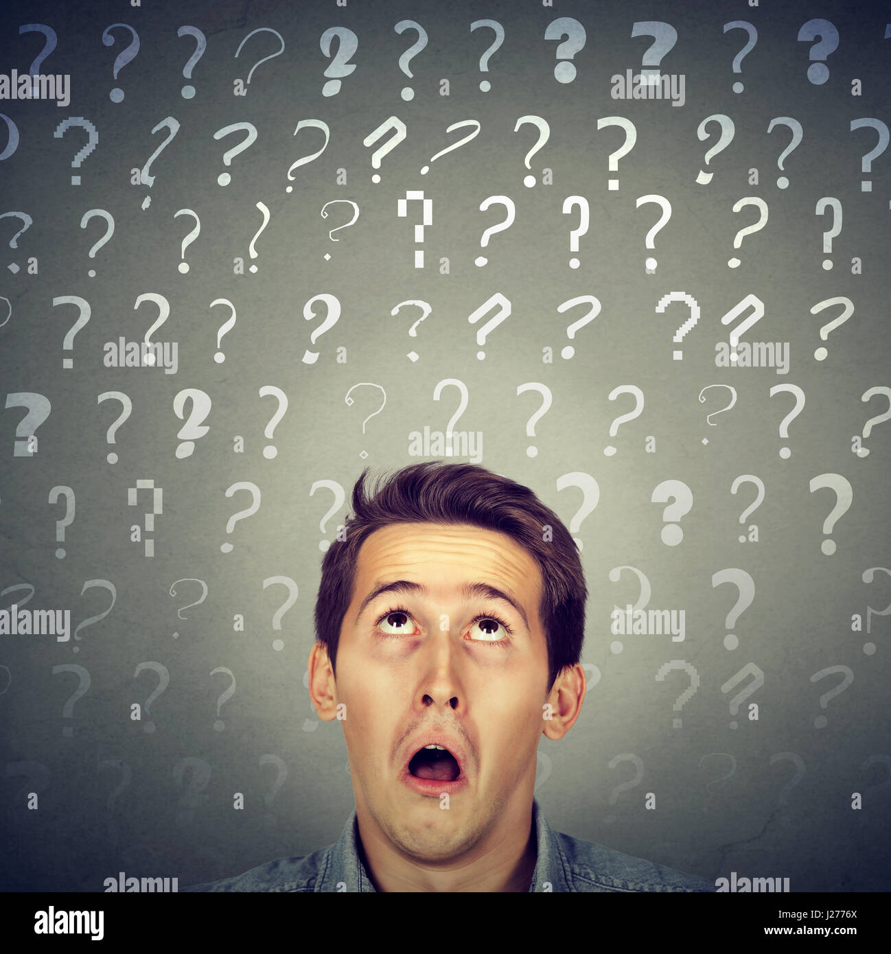 Confused curious shocked man thinking looking up has many questions and ...