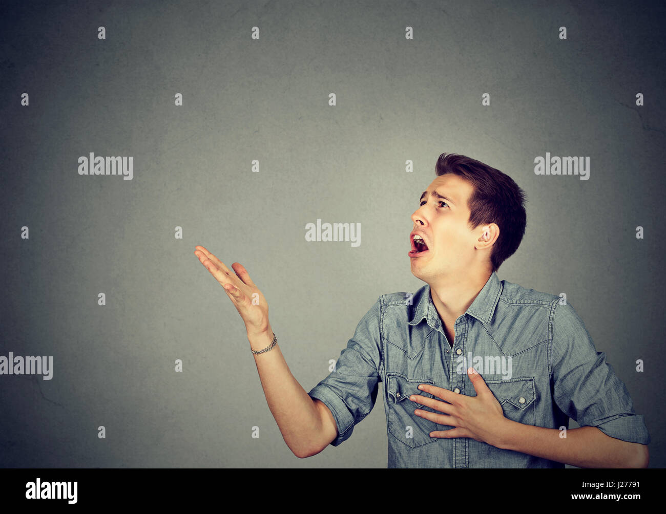 Desperate man screaming asking for help forgiveness Stock Photo - Alamy