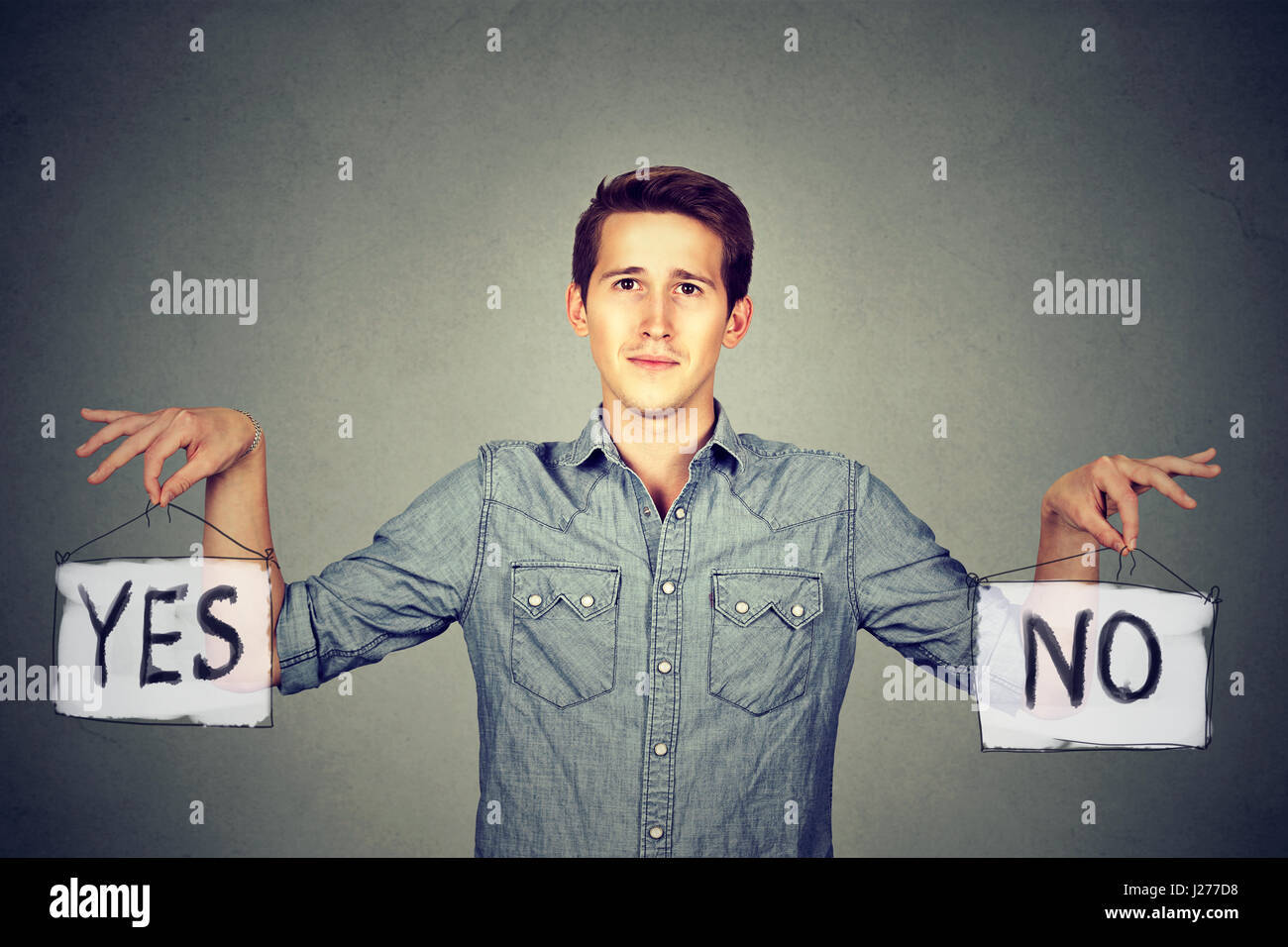 Man with yes no signs Stock Photo - Alamy