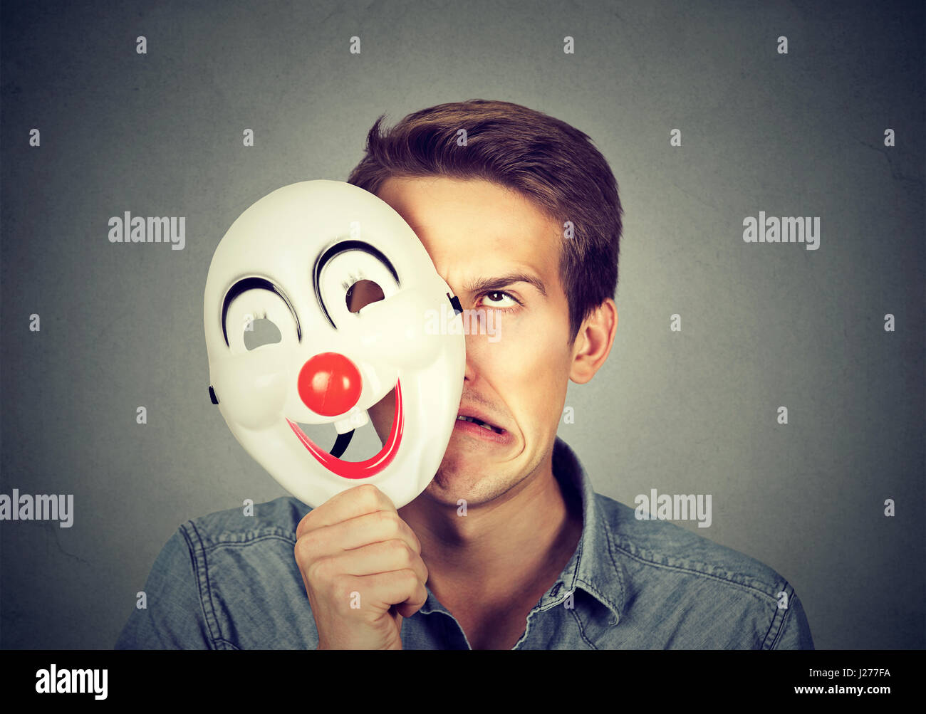 Face peeking behind mask hi-res stock photography and images - Alamy