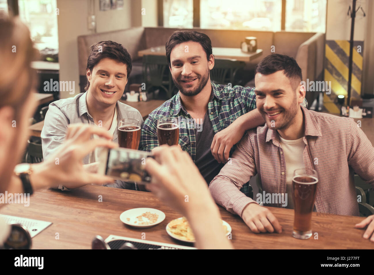 Friends having fun in pub Stock Photo - Alamy