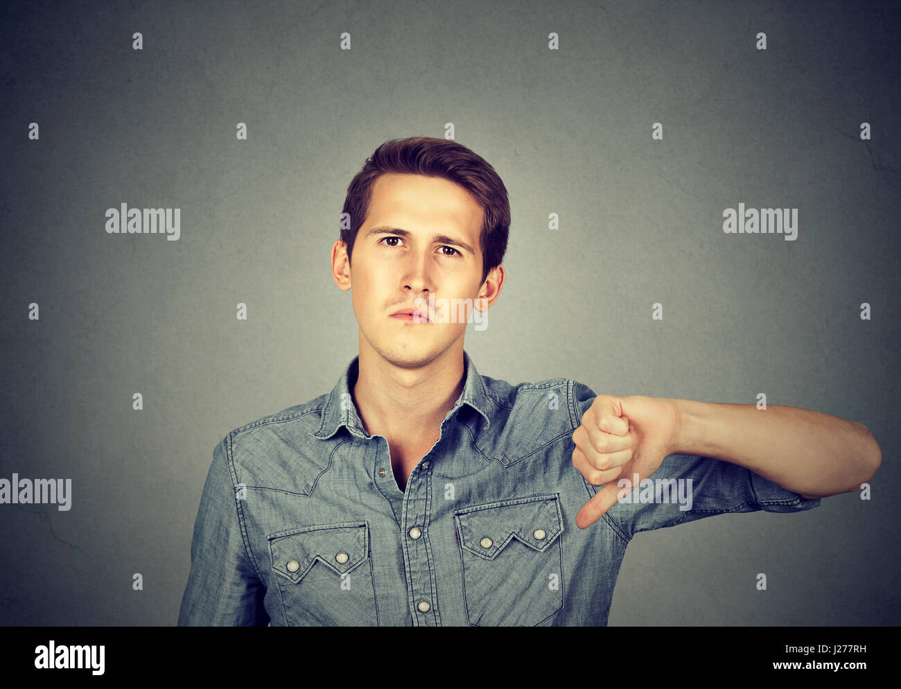Closeup portrait angry young man showing thumbs down sign, in ...