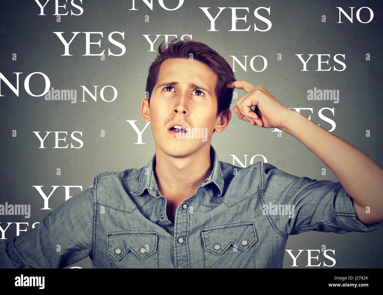 Headshot thinking perplexed young man with yes or no choice looking up ...