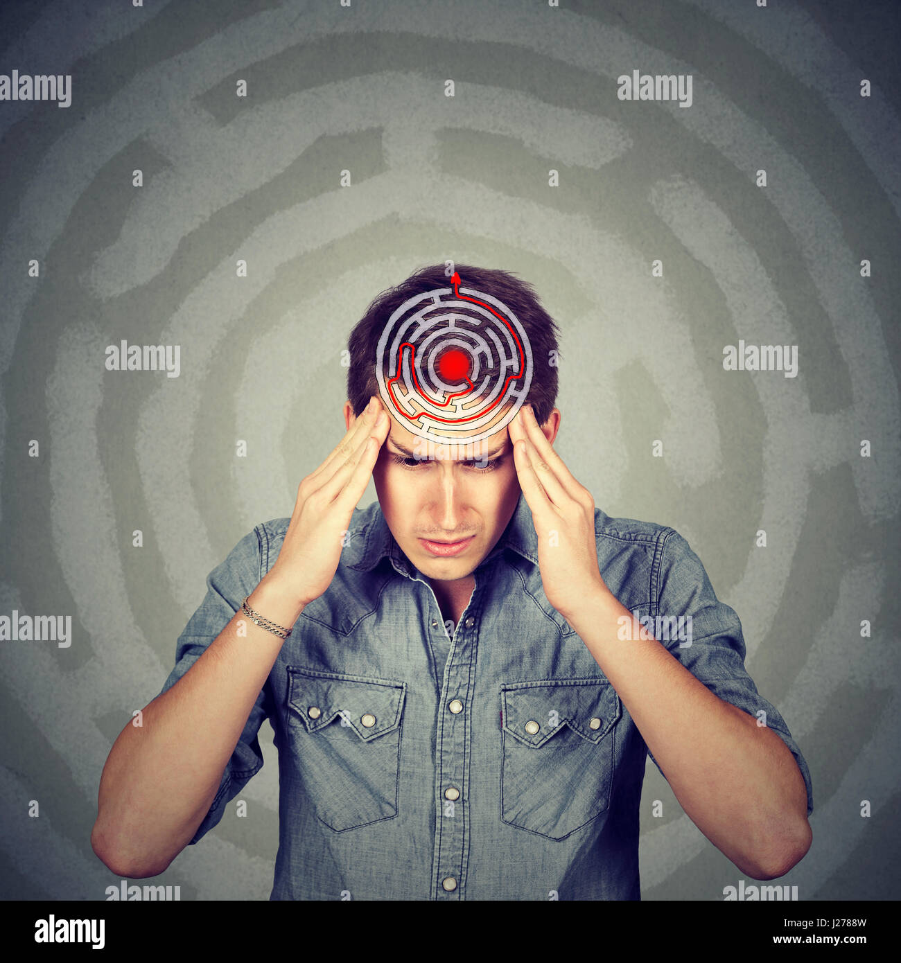 Problem solution concept. Young man solving puzzle isolated on gray ...