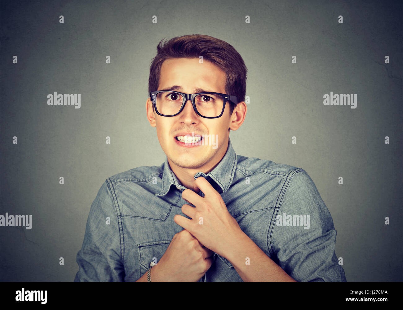 Nervous stressed young man student feels awkward looking at camera ...