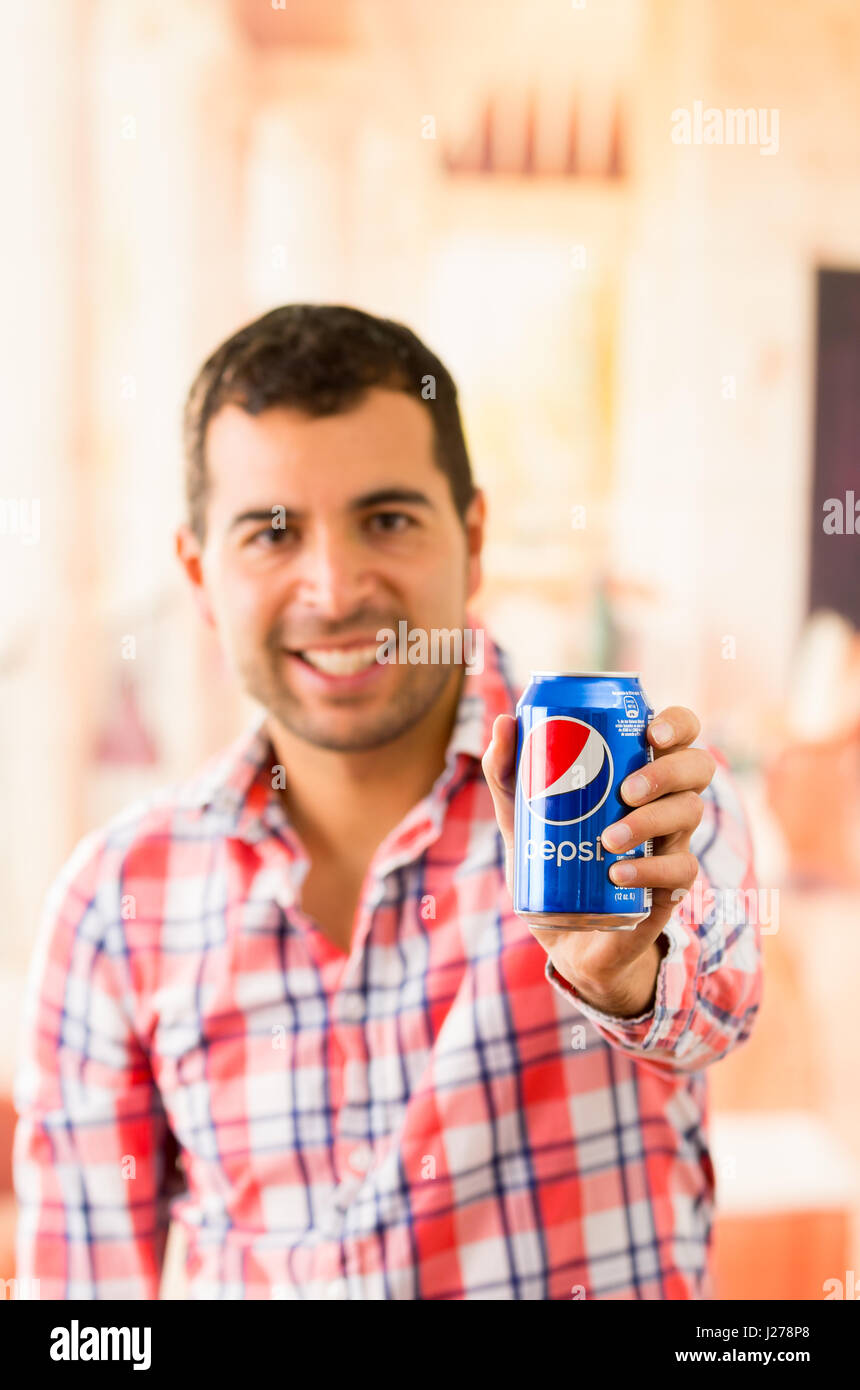Attractive young man smiling holding a Pepsi Cola can Stock Photo - Alamy