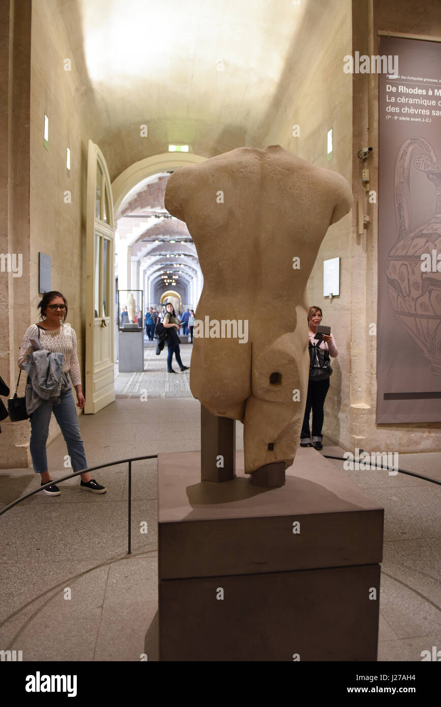 Visitors looking at the Miletus Torso statue in the corridor of the ...