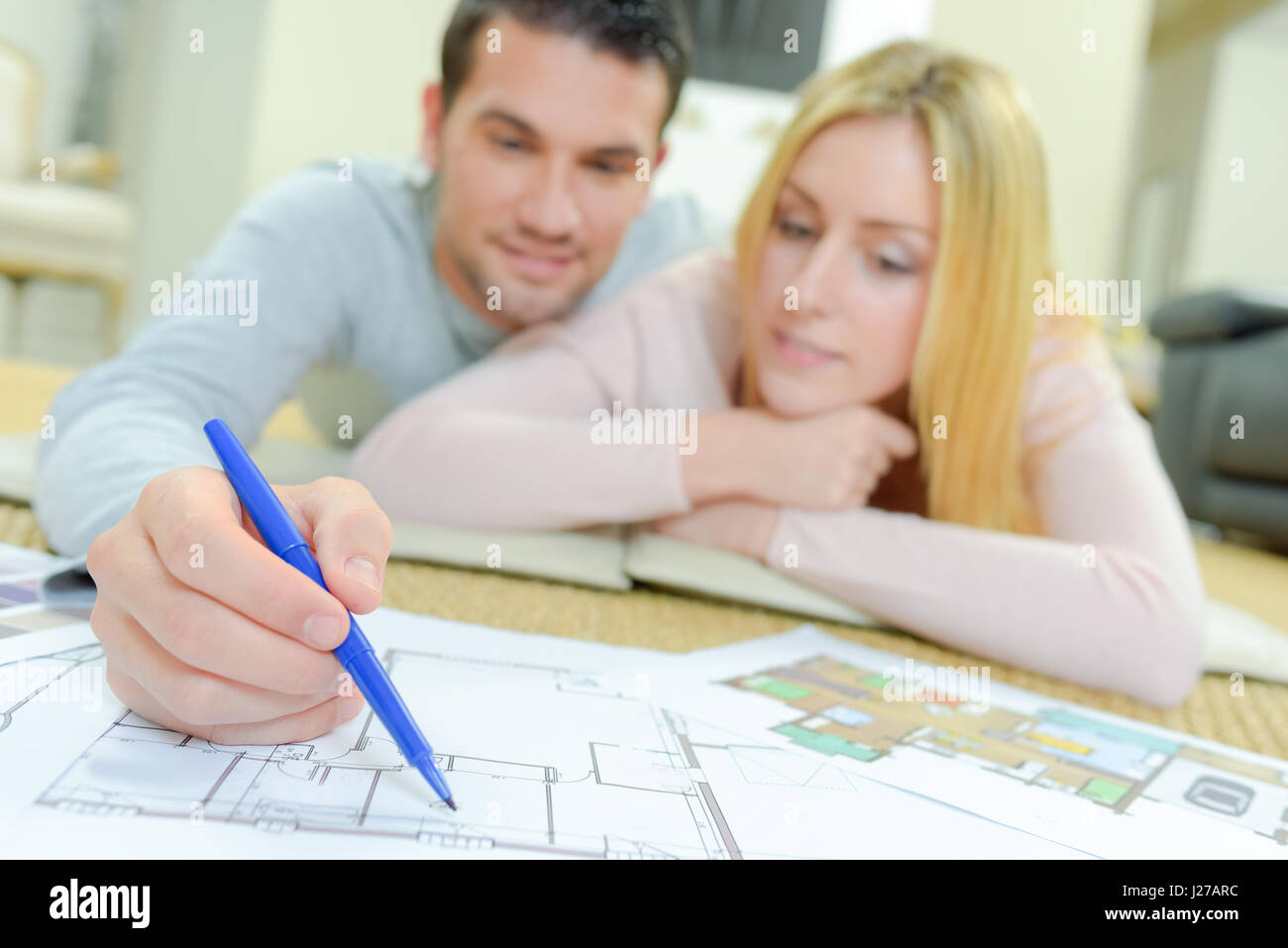 Couple looking house layout on hi-res stock photography and images - Alamy