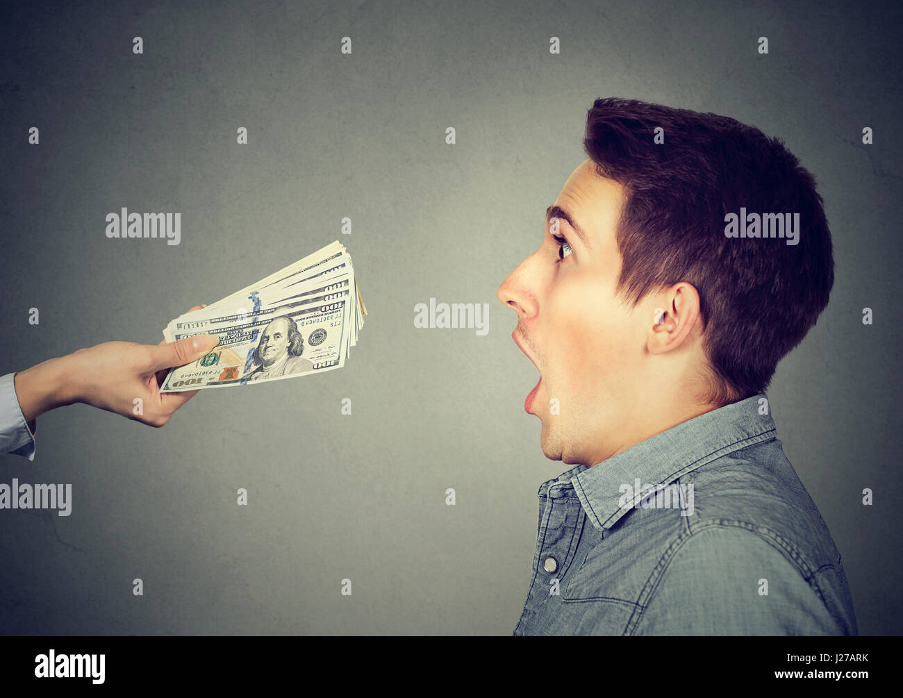 Shocked surprised man looking at offered cash dollar bills Stock Photo ...