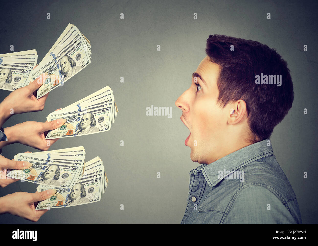Shocked man looking at many hands offering money dollar bills Stock ...