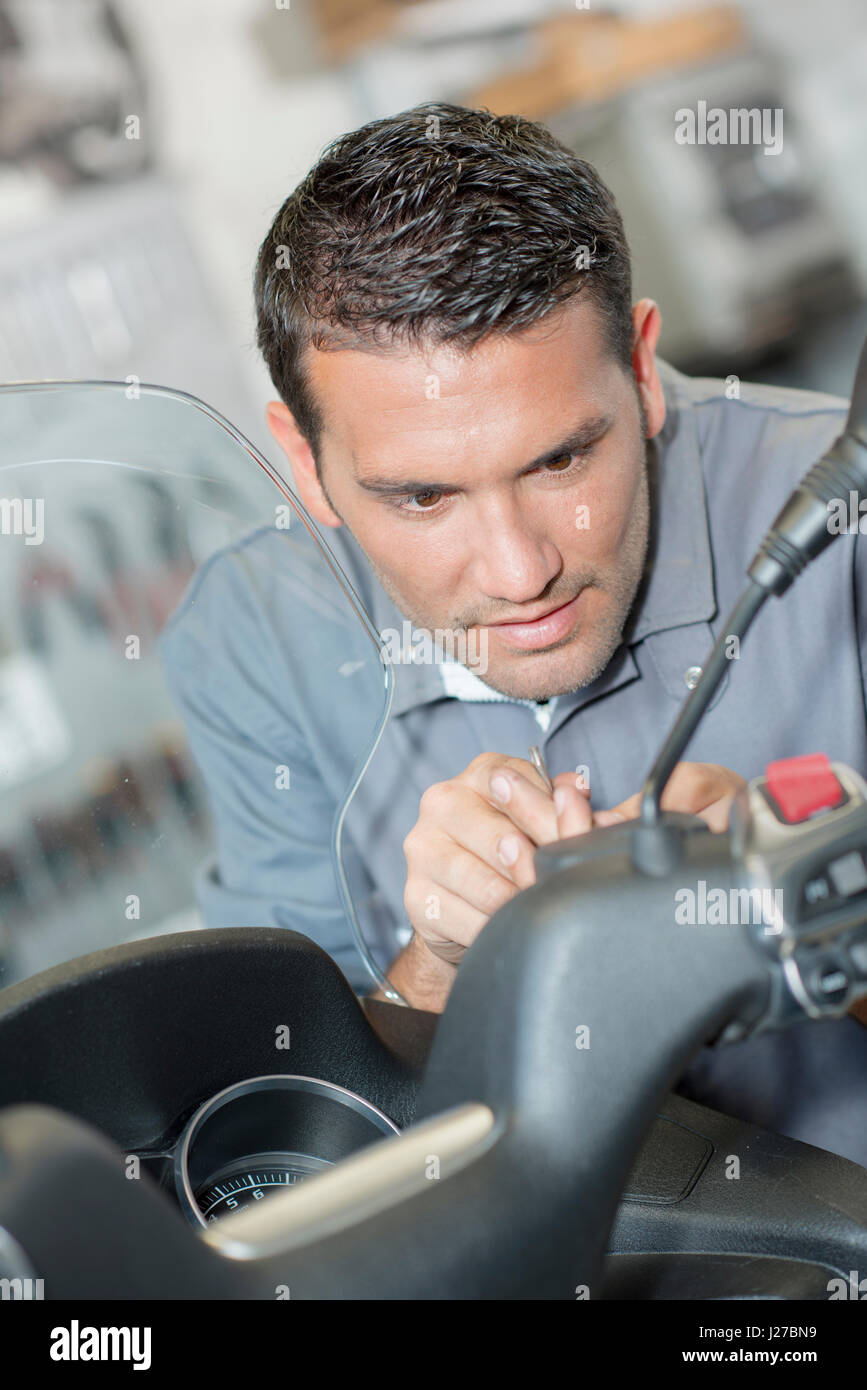 Mechanic repairing scooter hi-res stock photography and images - Alamy
