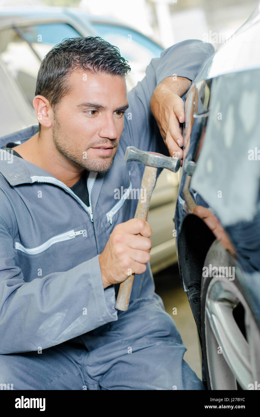 mechanic and the hammer Stock Photo - Alamy