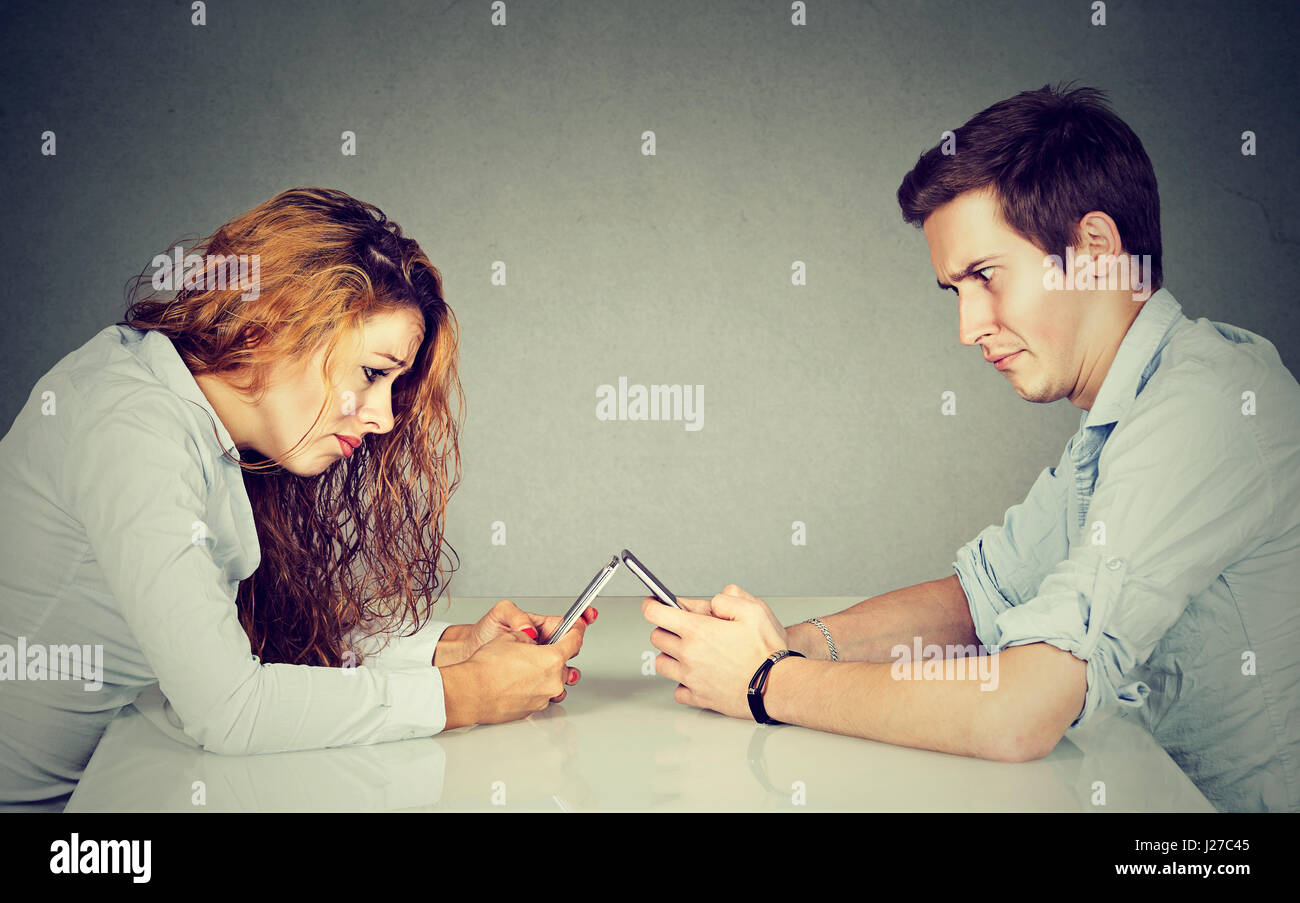 Smartphone addiction concept. Frustrated annoyed young woman and man ...