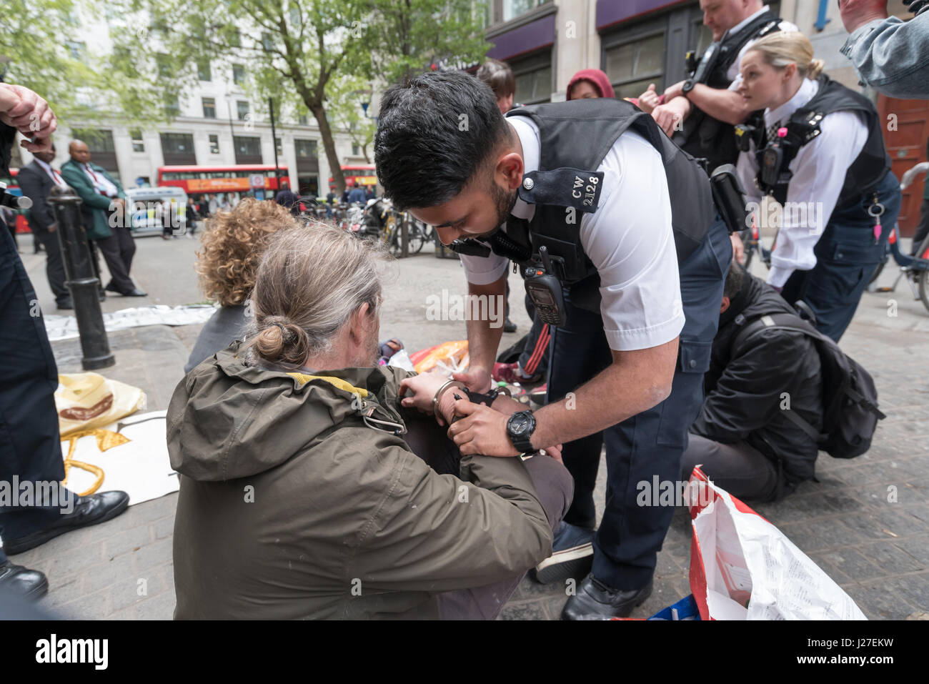 London, UK. 25th April 2017. Police handcuff Roger Hallam, one of the ...
