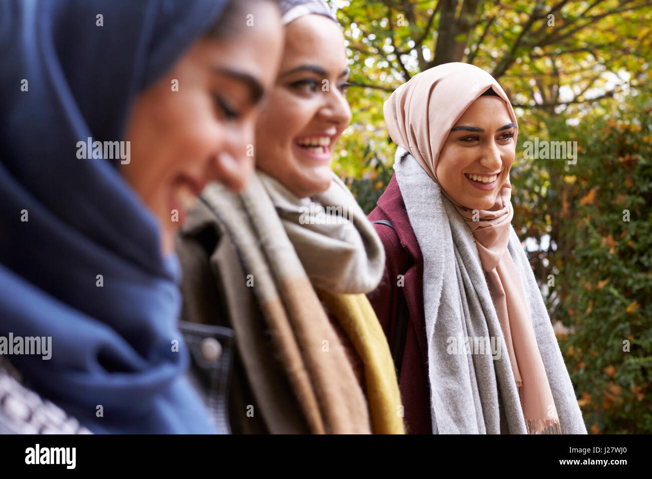 British Muslim Female Friends Meeting In Urban Environment Stock Photo ...