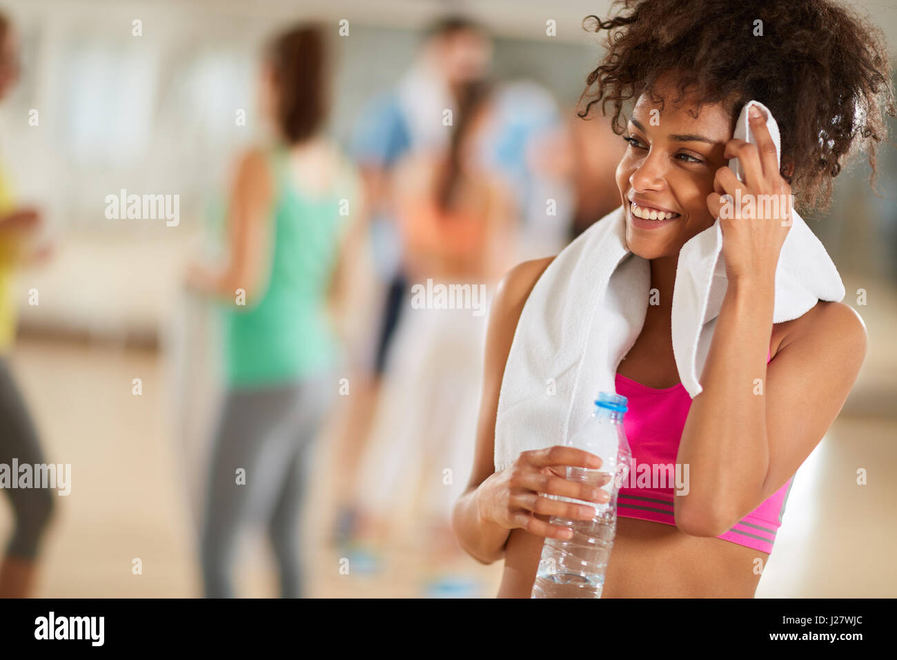 Tired and sweaty but satisfied mongrel woman after workout at gym Stock ...