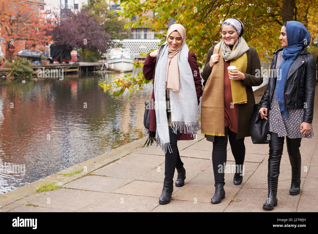 British Muslim Female Friends Walking By River In City Stock Photo - Alamy