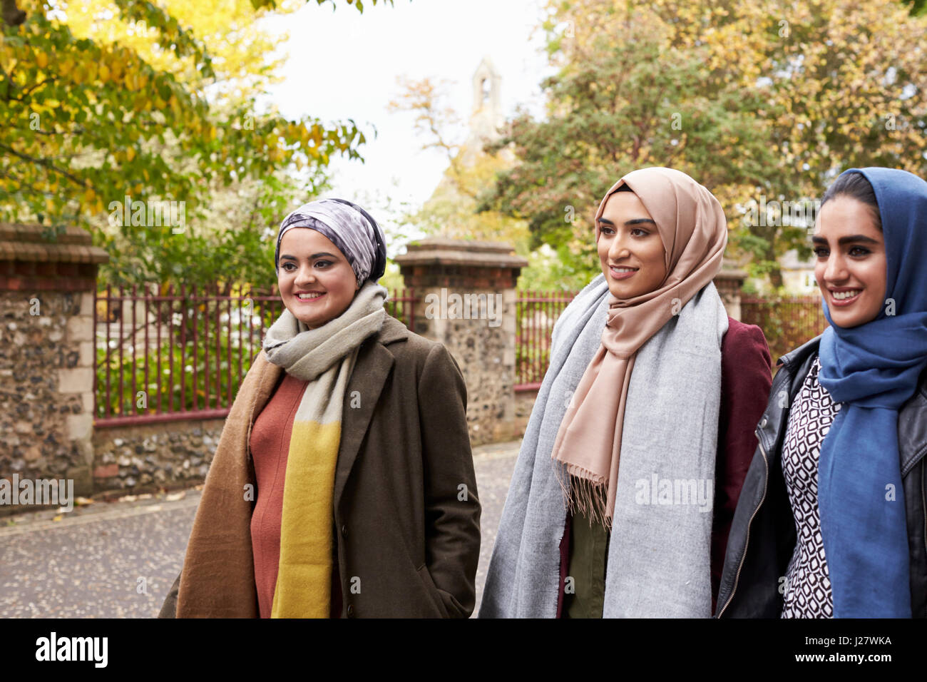 British Muslim Female Friends Walking In Urban Environment Stock Photo ...