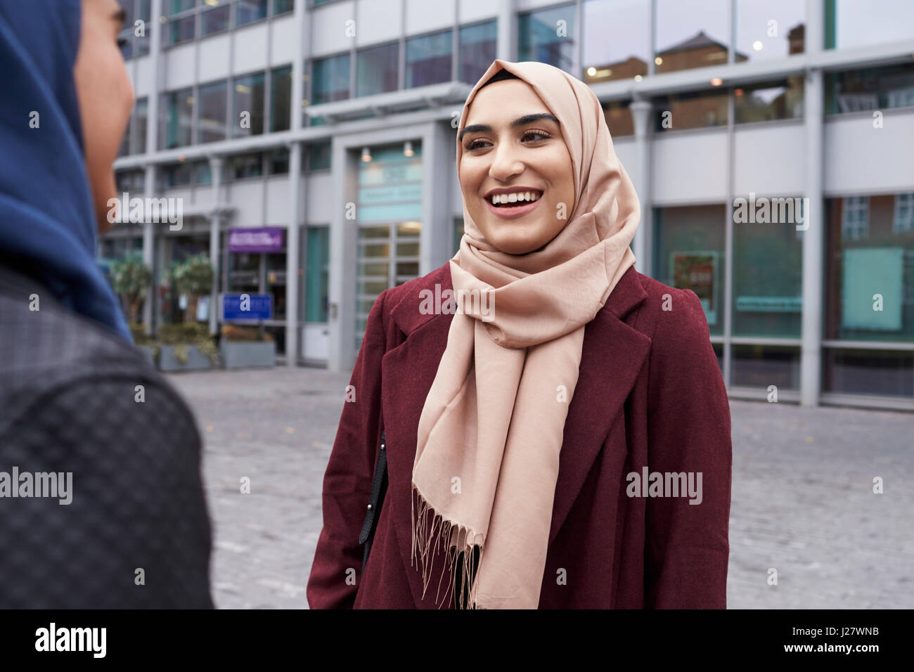 Two British Muslim Women Friends Meeting Outside Office Stock Photo - Alamy