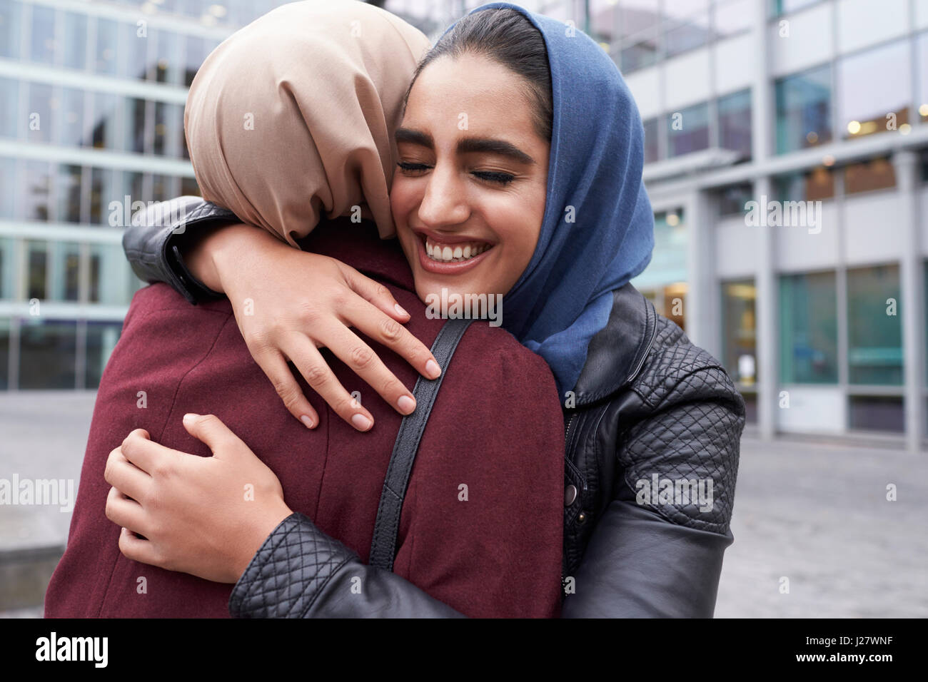 Two British Muslim Women Friends Meeting Outside Office Stock Photo - Alamy