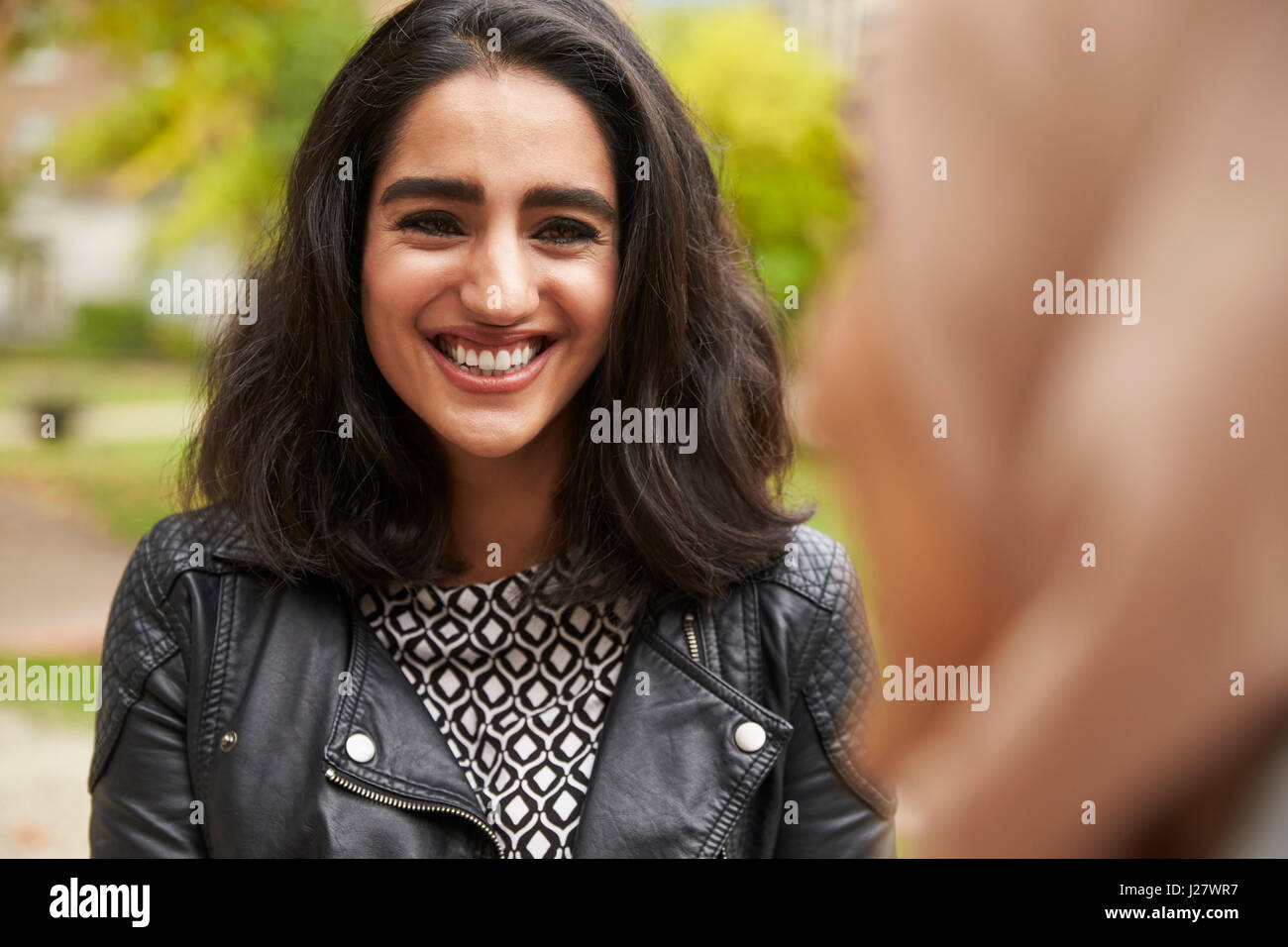 Two British Muslim Women Meeting In Urban Park Stock Photo - Alamy