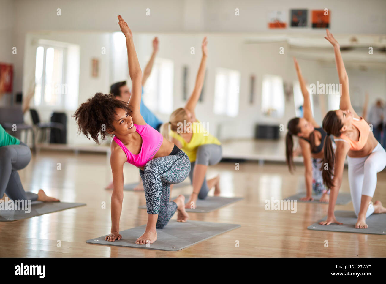 Group women trainer yoga exercises hi-res stock photography and images ...