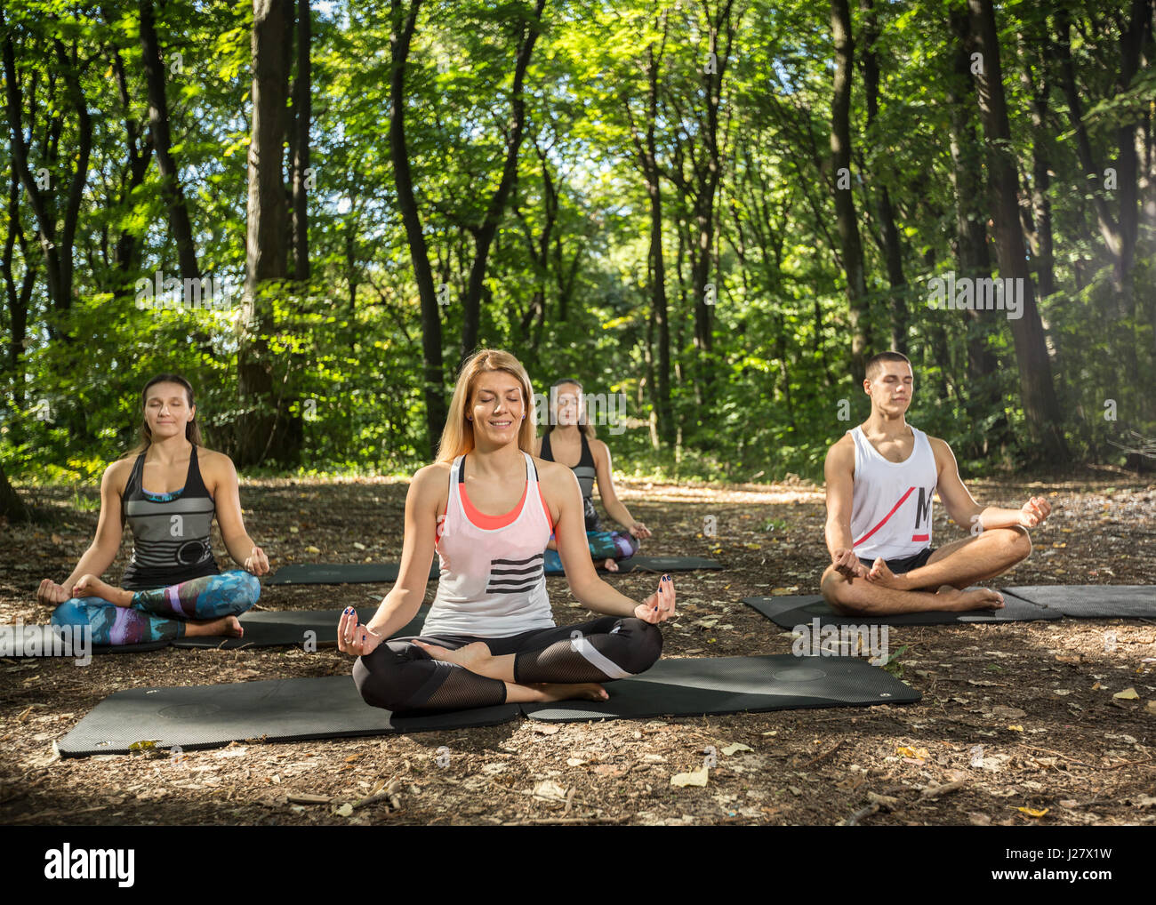 Three young female doing balance exercises in harmony of nature Stock ...
