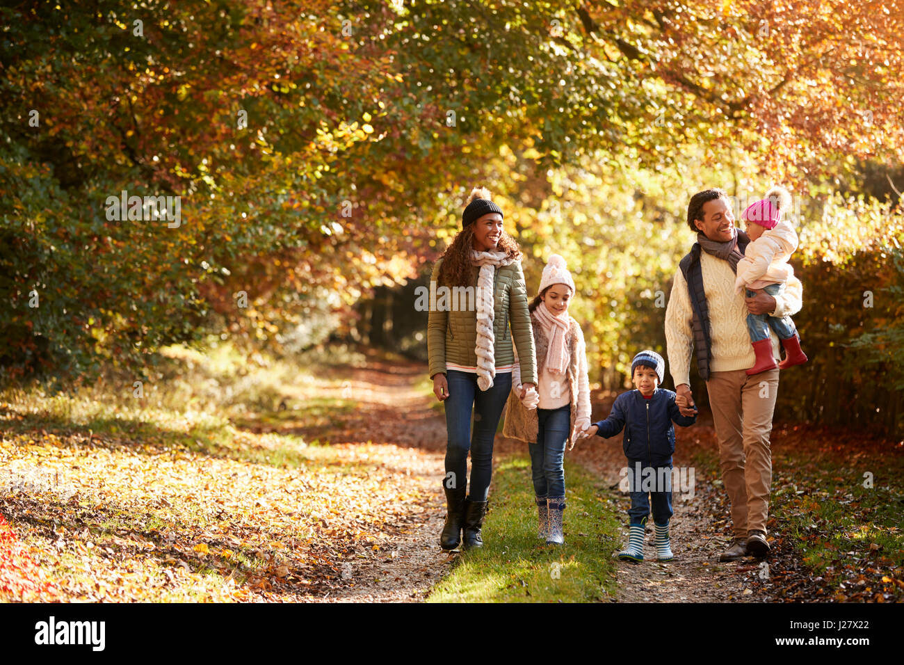 Front View Of Family Enjoying Autumn Walk In Countryside Stock Photo ...