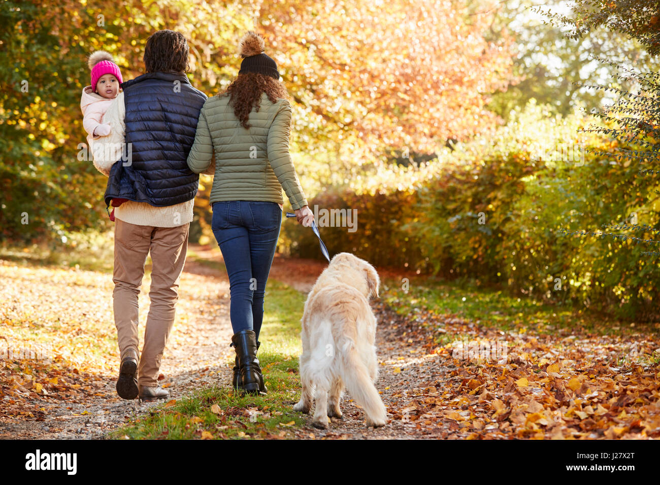 Family With Daughter And Dog Enjoy Autumn Countryside Walk Stock Photo ...
