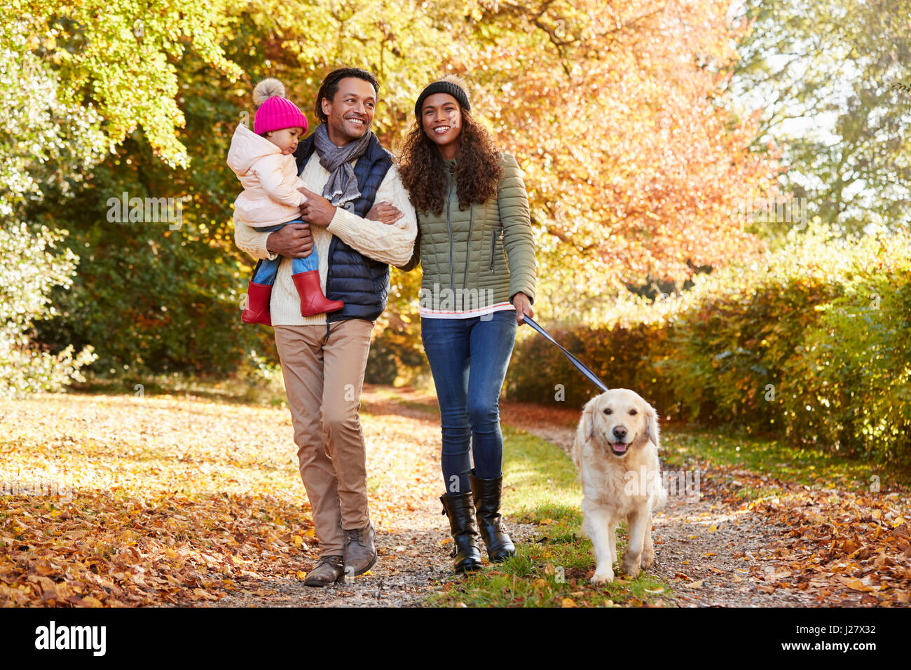 Family With Daughter And Dog Enjoy Autumn Countryside Walk Stock Photo ...