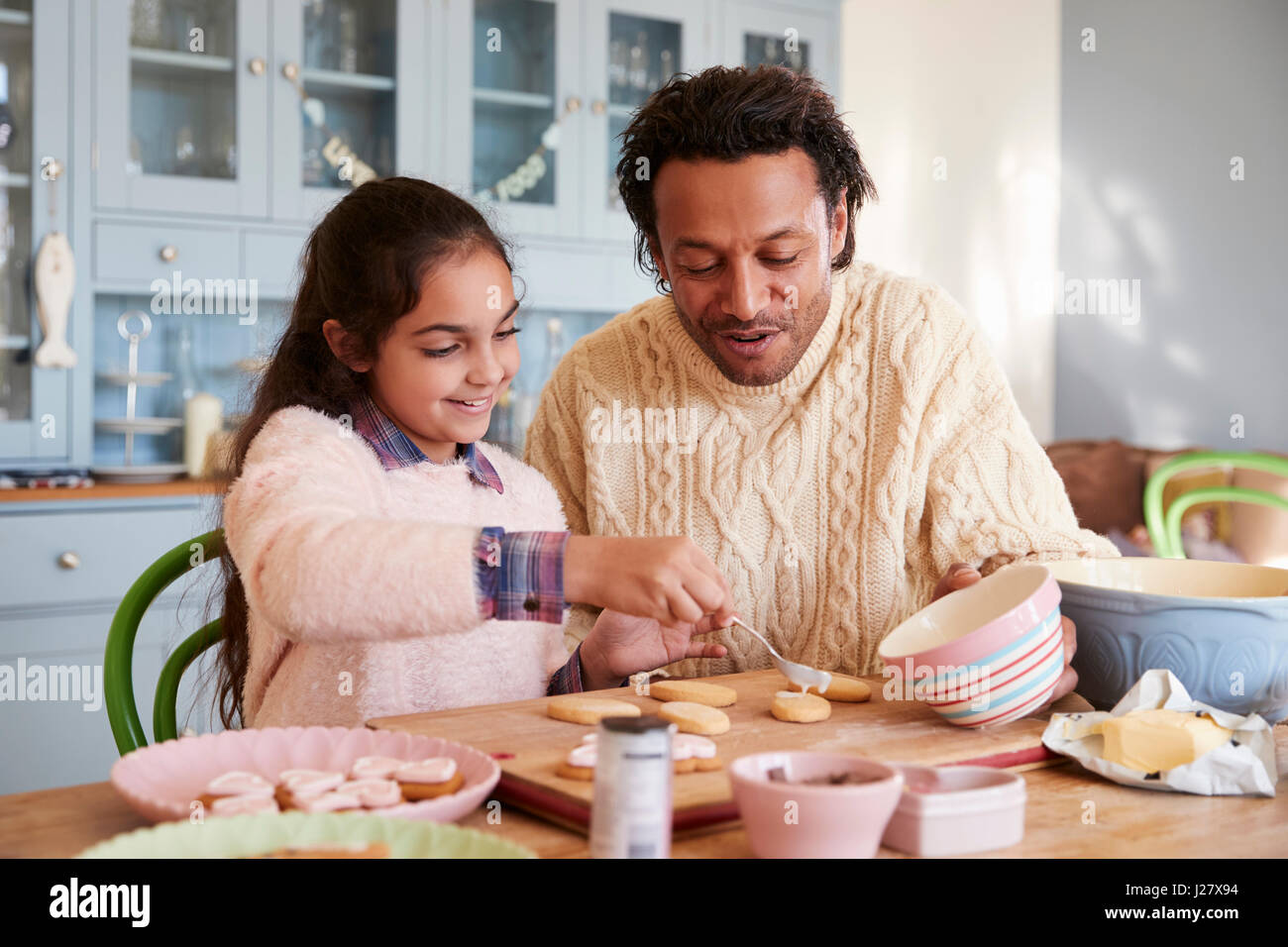 Father And Daughter Decorating Cookies At Home Together Stock Photo - Alamy